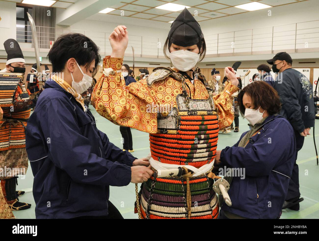 A woman receives help getting into samurai armor ahead of an annual New ...