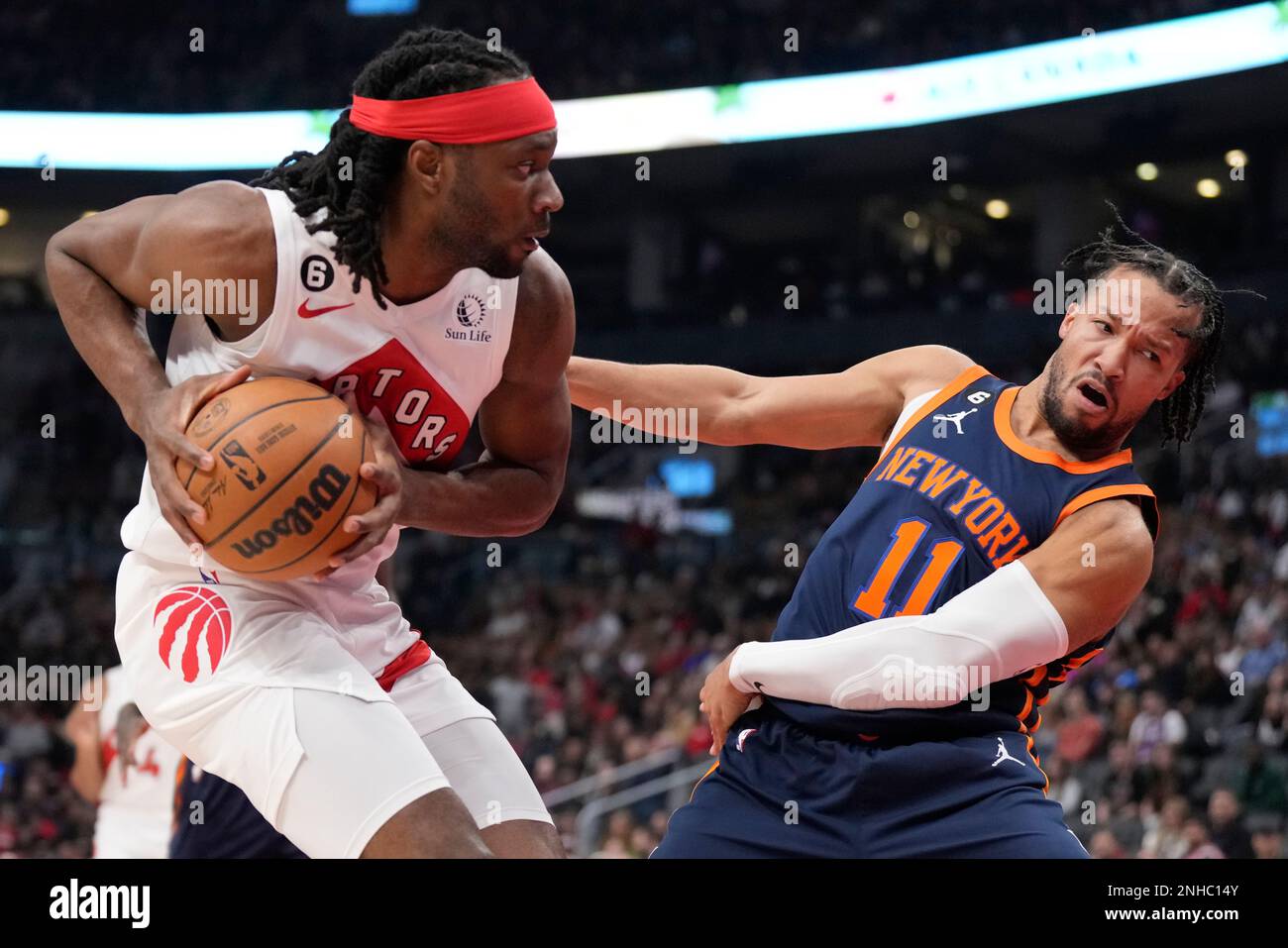 Toronto Raptors forward Precious Achiuwa, left, picks up an offensive ...