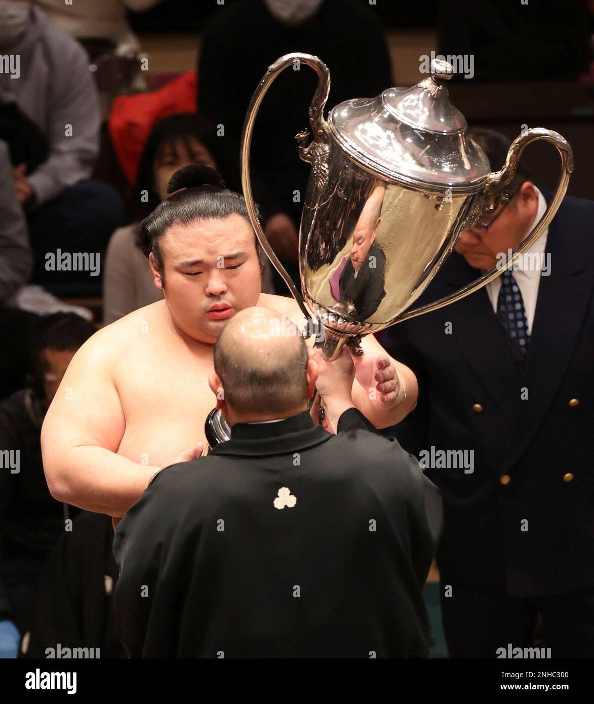 Japanese Ozeki Takakeisho receives a victory trophy during a final day ...