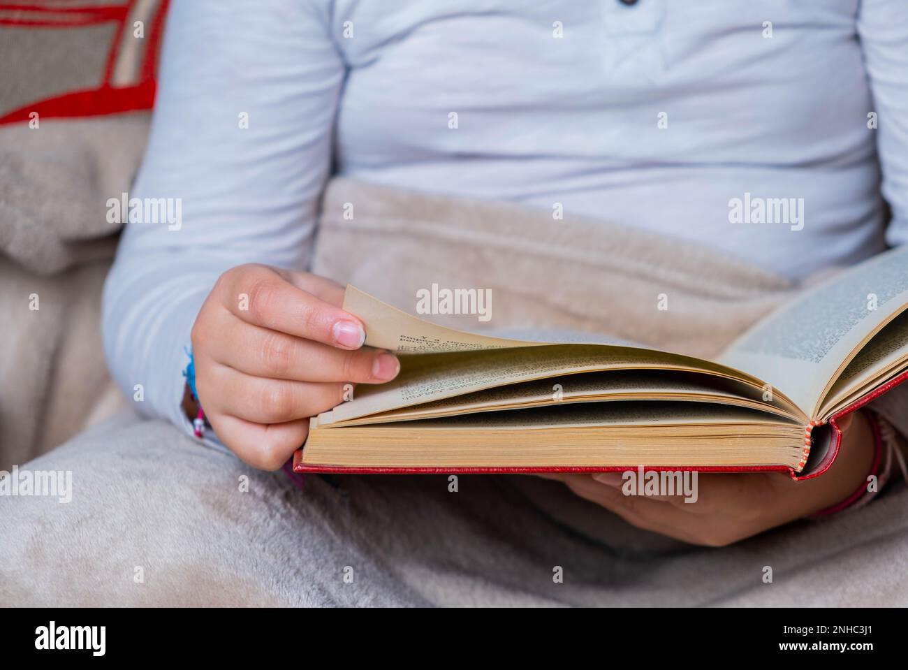 Plane details from the hand of a girl by passing the page of a book ...