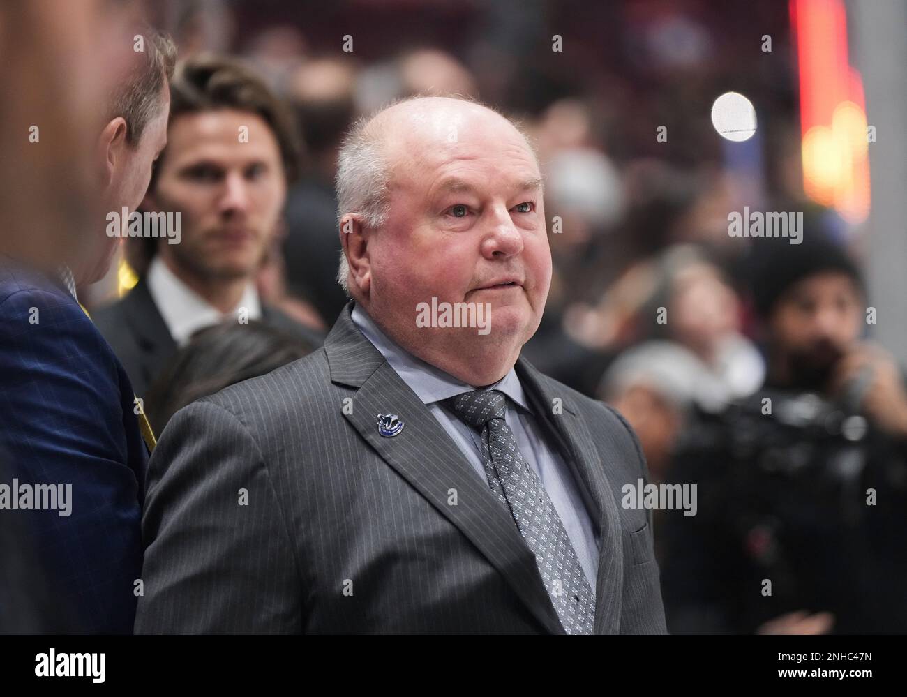 Vancouver Canucks coach Bruce Boudreau stands behind the bench before ...