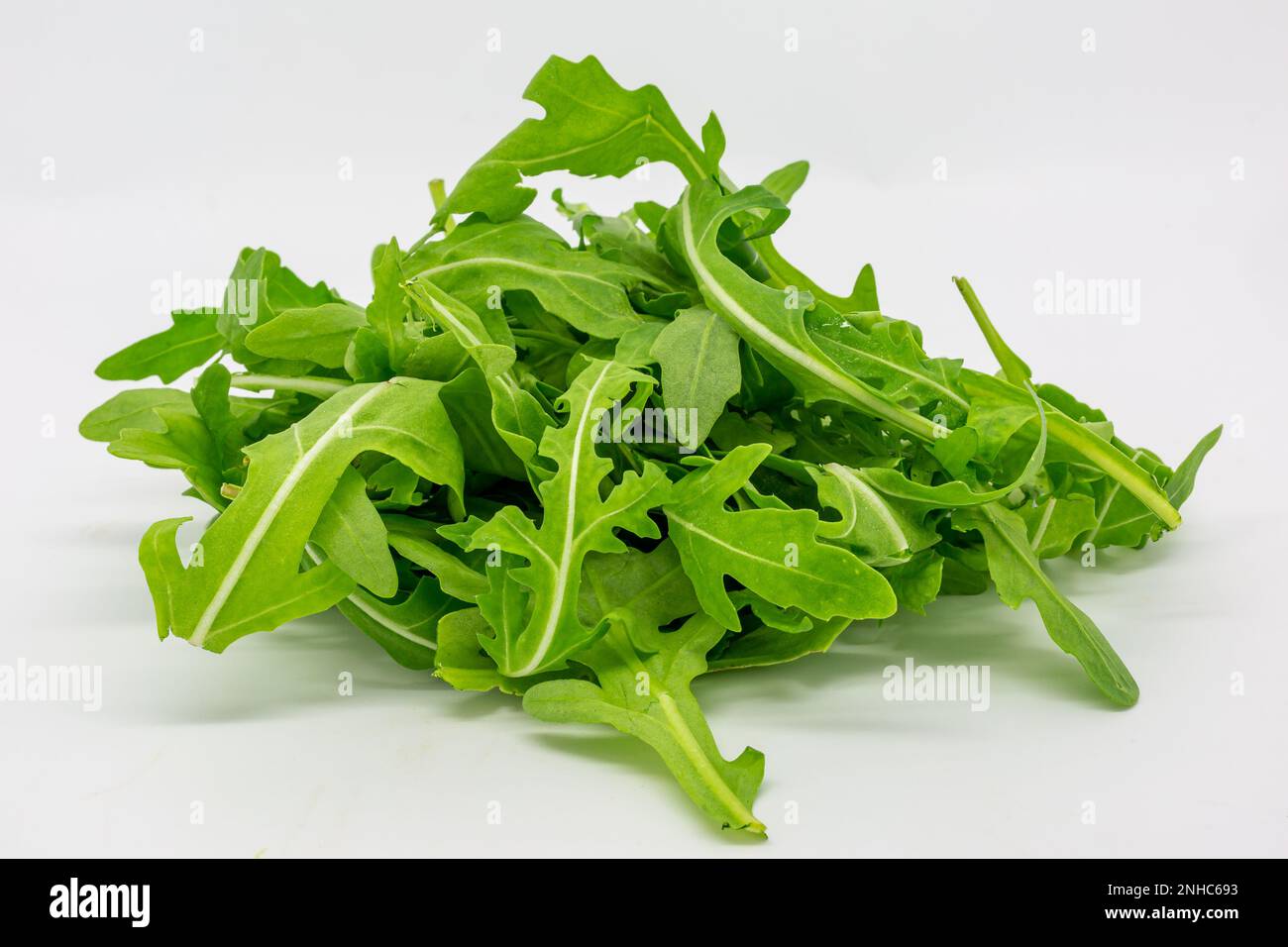 Fresh rocket leaves against a white background Stock Photo - Alamy