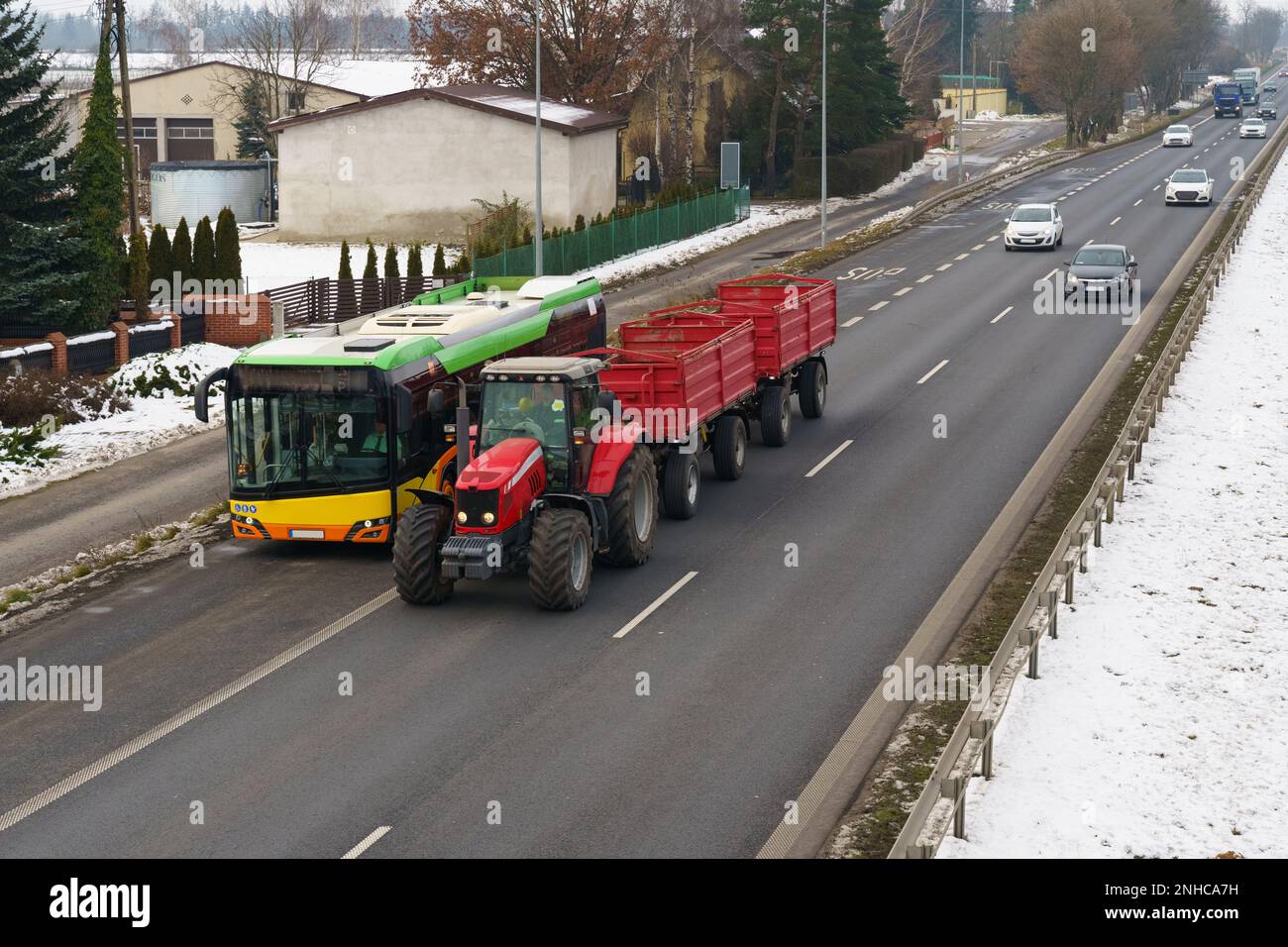 Traffic on the motorway. A bus, tractor, trucks and cars are traveling ...