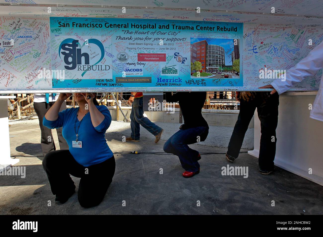 People sign the surface of the beam, as San Francisco General Hospital ...