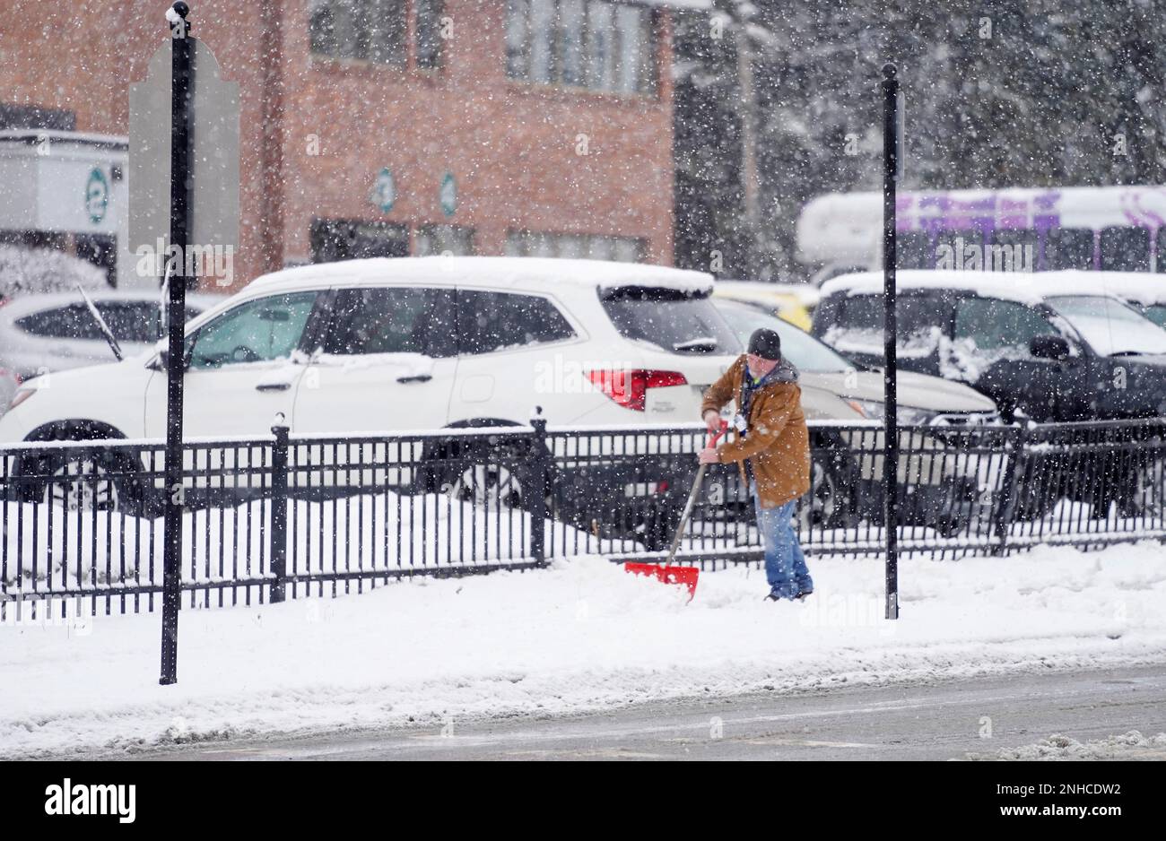A man shovels the sidewalk on Maplewood Ave. as snow falls, Friday, Jan ...