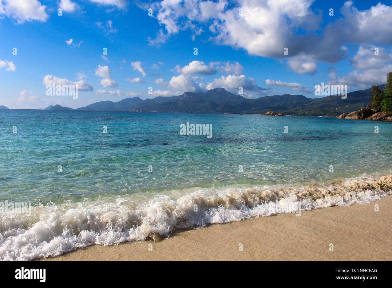 The azure blue waters off the Anse Soleil Beach in Mahe Island ...
