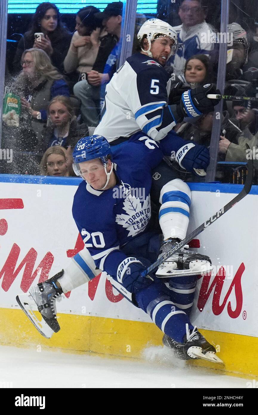 Toronto Maple Leafs left wing Dryden Hunt (20) checks Winnipeg Jets ...