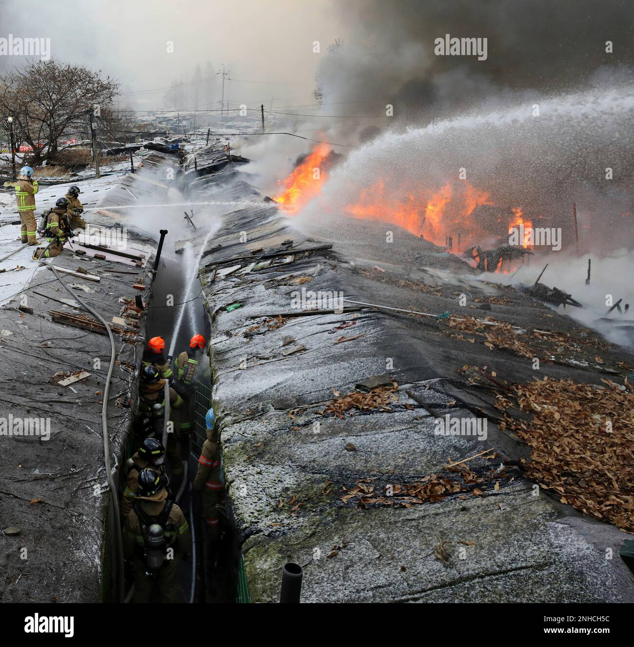 Firefighters battle a fire at Guryong village in Seoul, South Korea ...