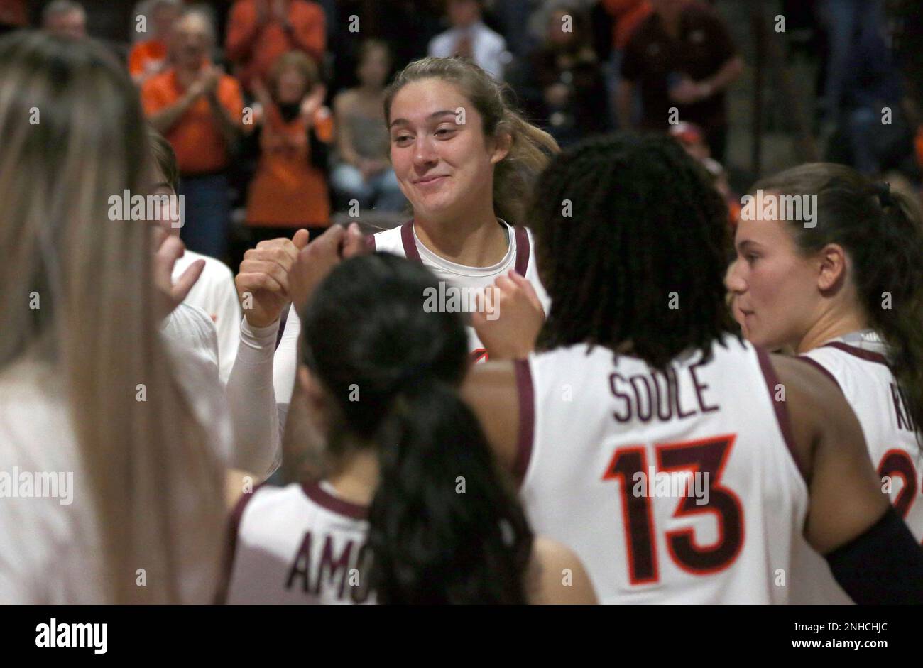 Virginia Tech's Elizabeth Kitley (33) center, huddles with her ...