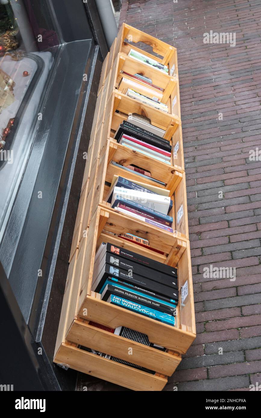 slanted wooden boxes filled with books outdoors for a store front Stock ...