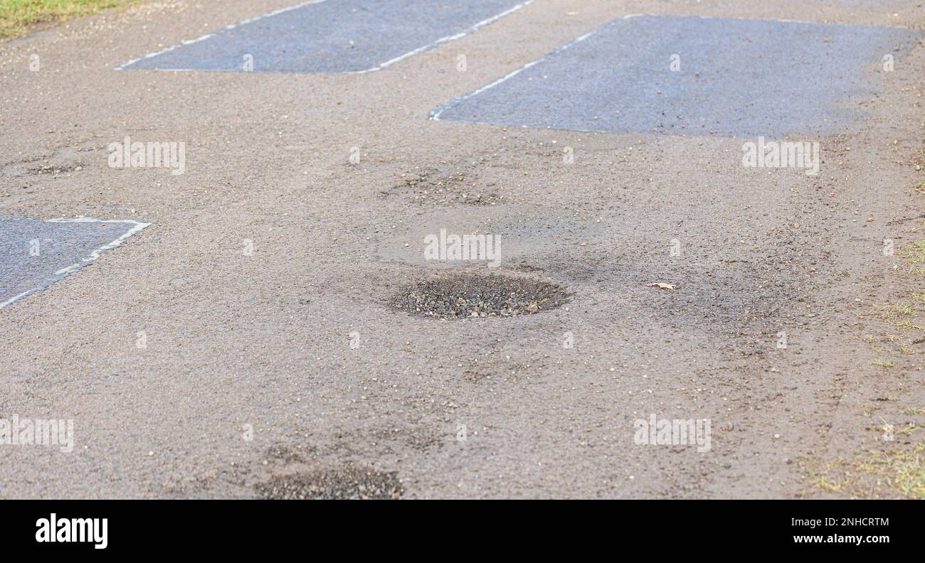 Road Damage and repair, pot holes and patch work Stock Photo - Alamy