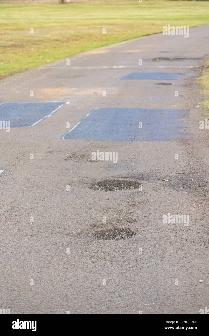 Road Damage and repair, pot holes and patch work Stock Photo - Alamy