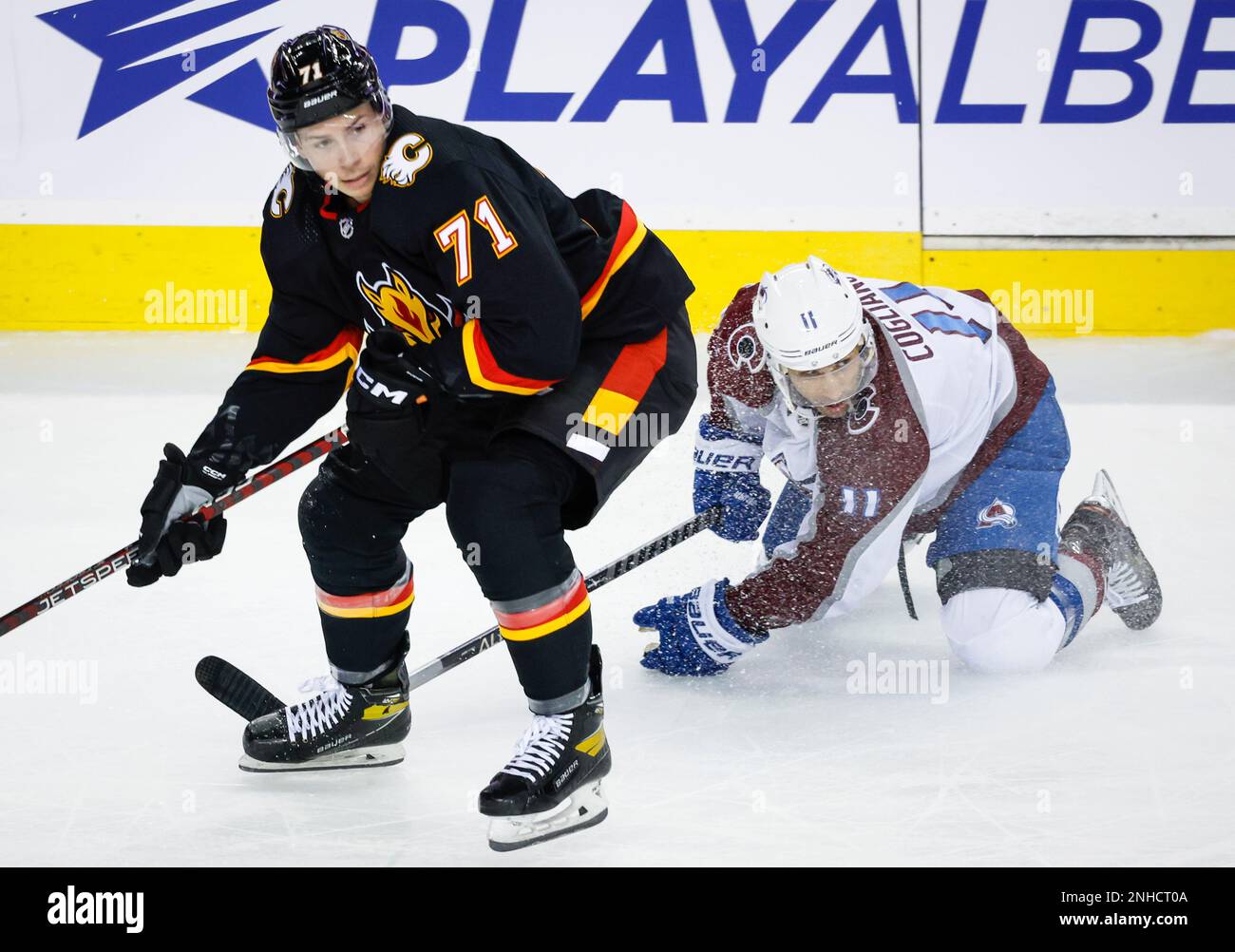 Colorado Avalanche forward Andrew Cogliano, right, is checked by ...