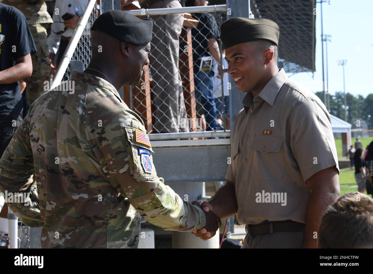 Pvt. Tyrice Melvin, who graduated Basic Combat Training, shakes hands ...