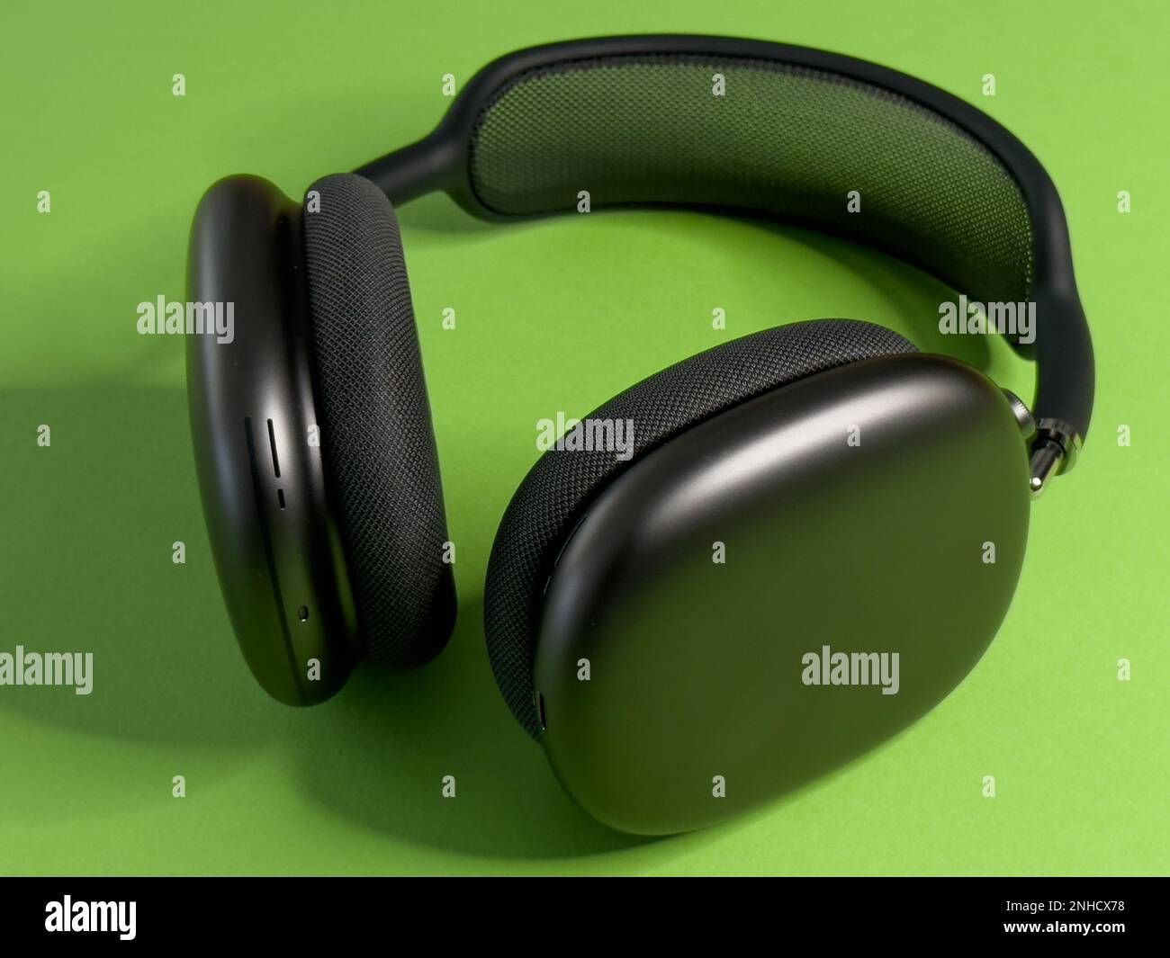 a beautiful pair of space gray Apple Airpods Max headphones, on a clear ...