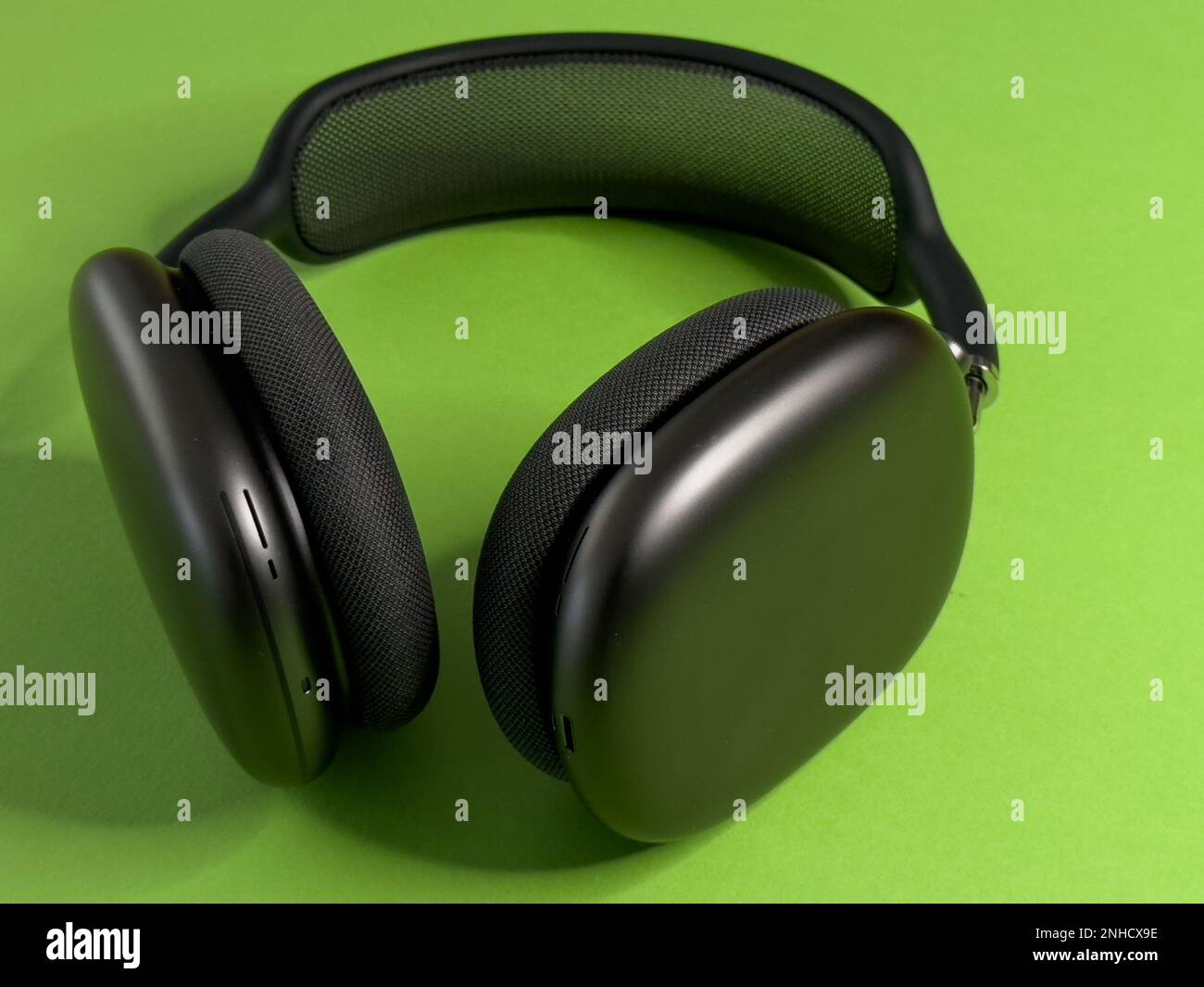 a beautiful pair of space gray Apple Airpods Max headphones, on a clear ...