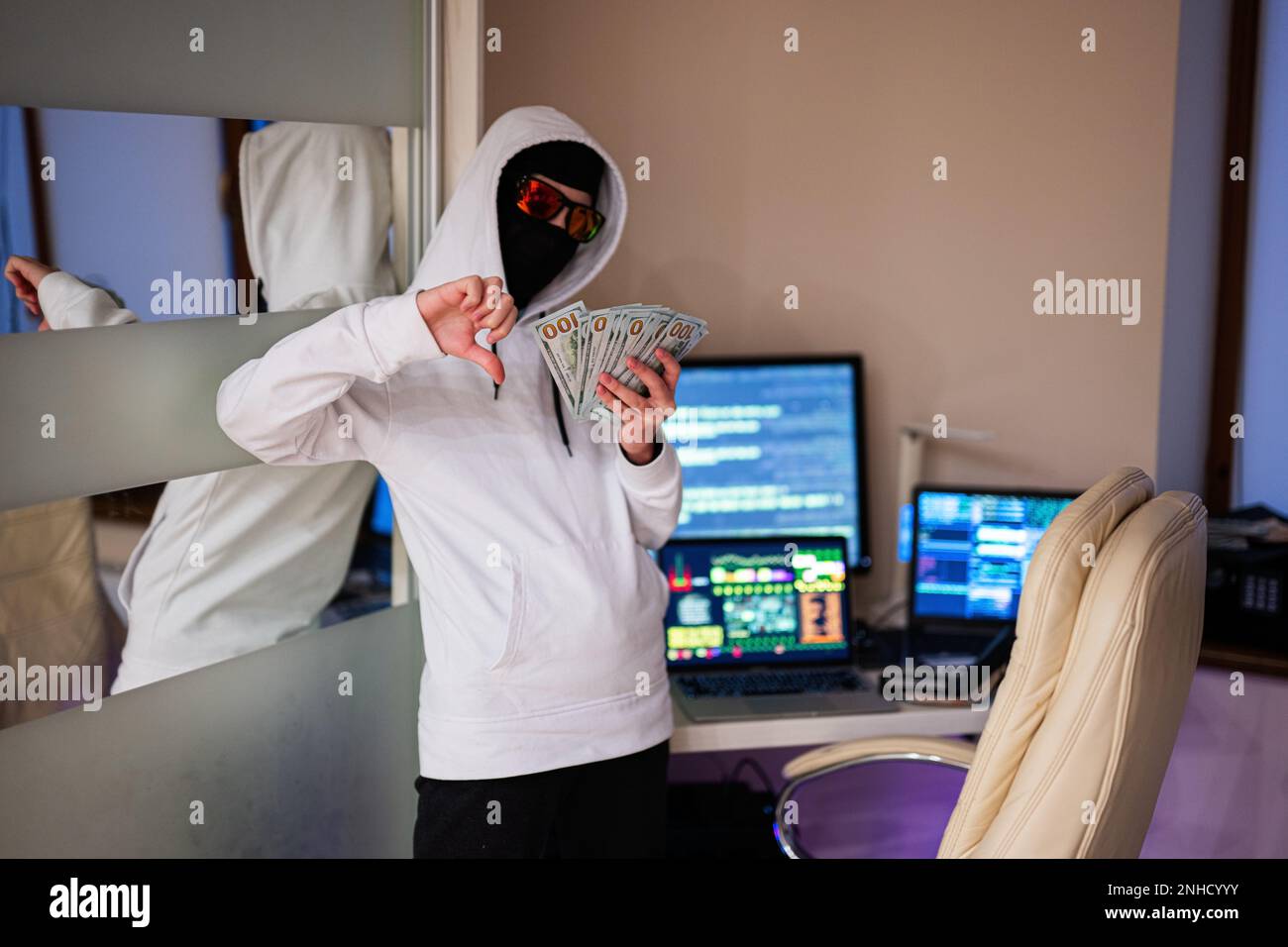 Boy hacker with money dollars, show down finger. Internet theft . Man ...