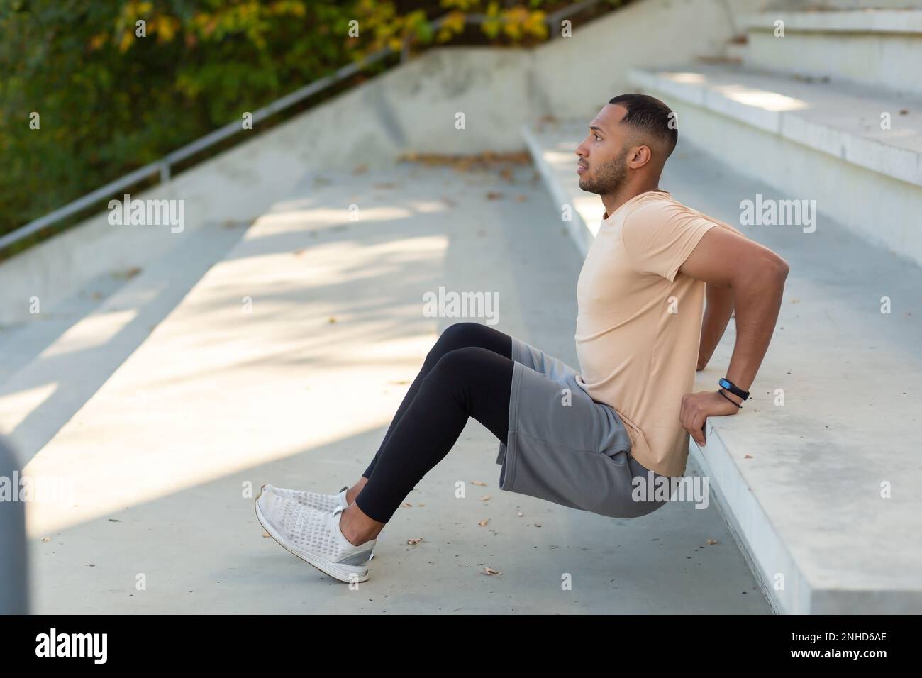 Young african american male athlete doing exercises in stadium on ...