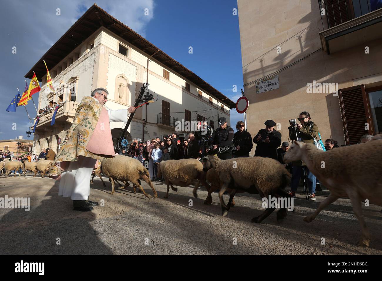 A man dressed as a 'payase' marks the passage of a set of sheep in the ...