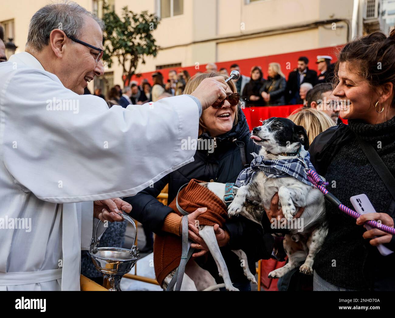 Two women attend with their dogs to the traditional blessing and parade ...
