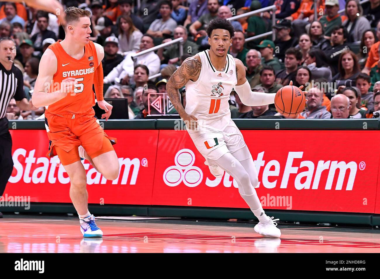 CORAL GABLES, FL - JAN 16: Miami guard Jordan Miller (11) brings the ...