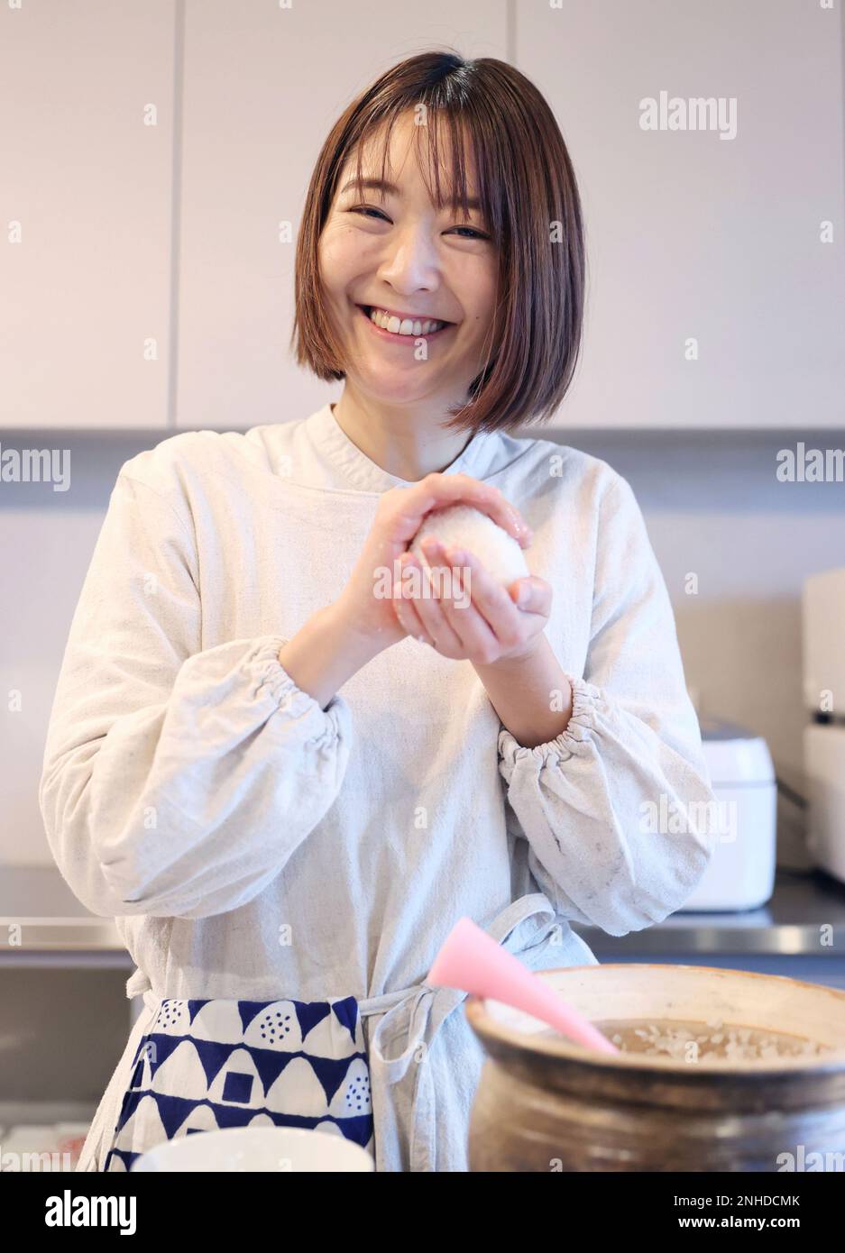 Kana Kanamoto cooks onigiri (omusubi / nigirimeshi), Japanese rice ball, in Shibuya Ward, Tokyo ...