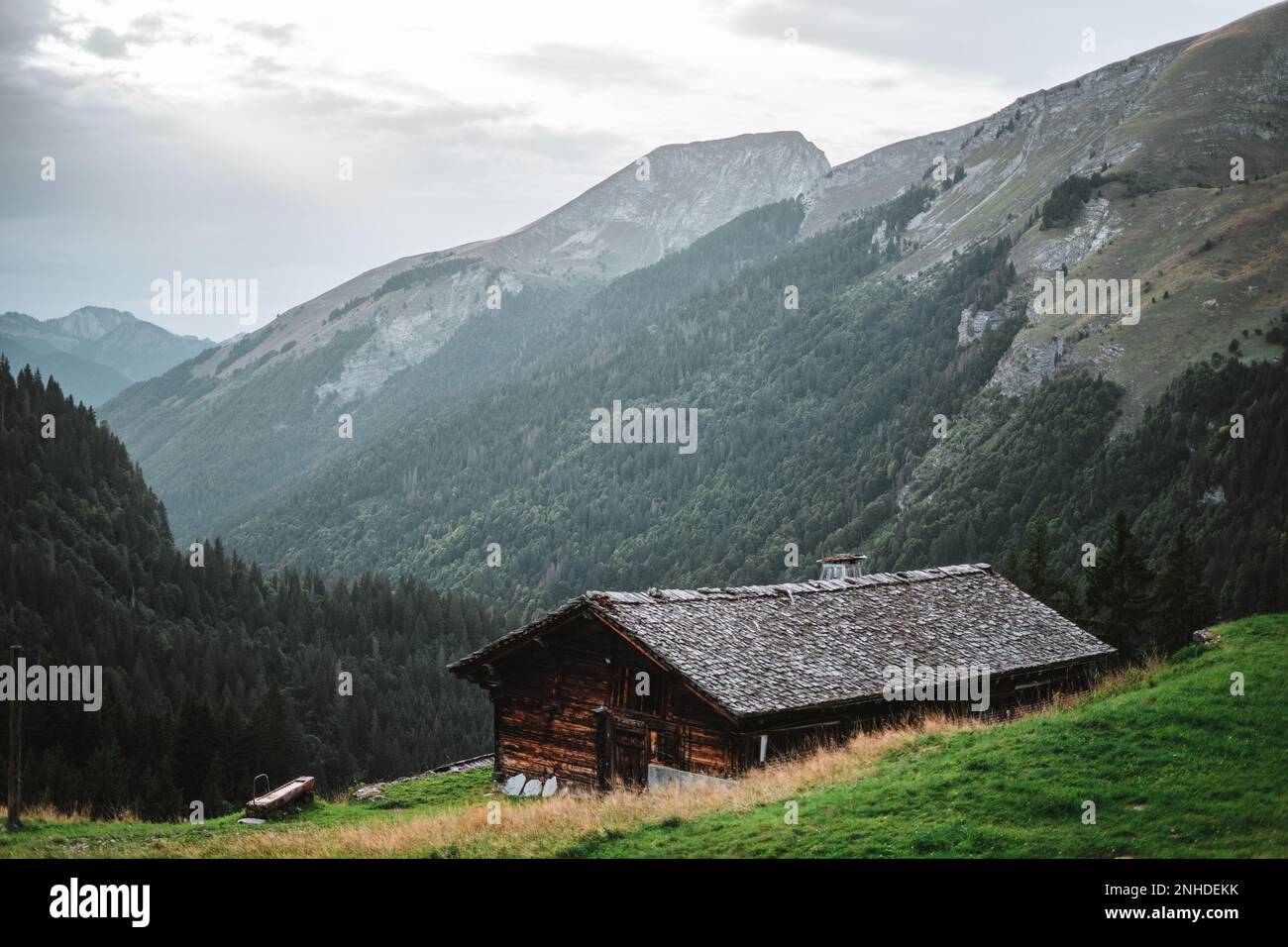Wooden hut in the alps with mountains in the background Panorama Stock ...