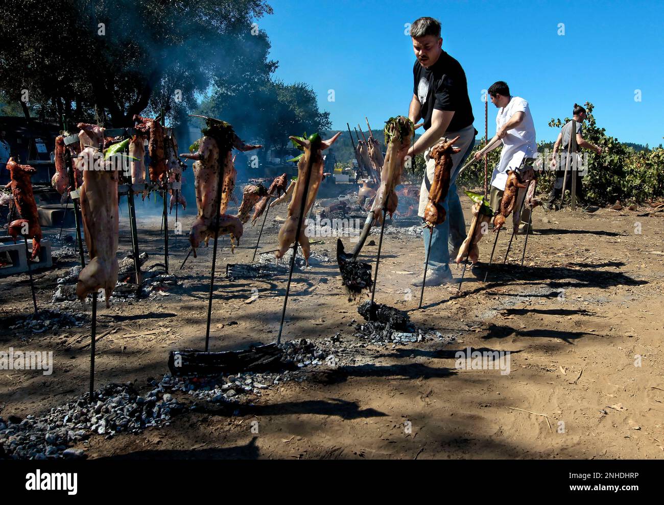 Bob Sully of Blackberry Farms Chateau in Tennessee shovels hot coals as ...