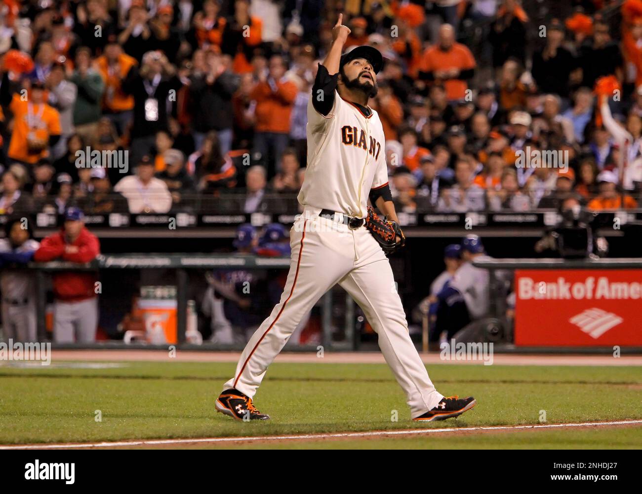 Giants relief pitcher Sergio Romo points skyward as he comes out of the game in the eighthn ...