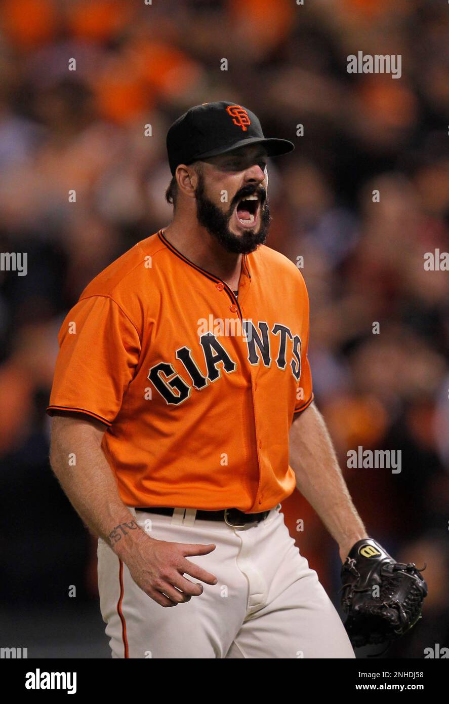 Giants pitcher Brian Wilson reacts as he closes out the 8th inning, as ...