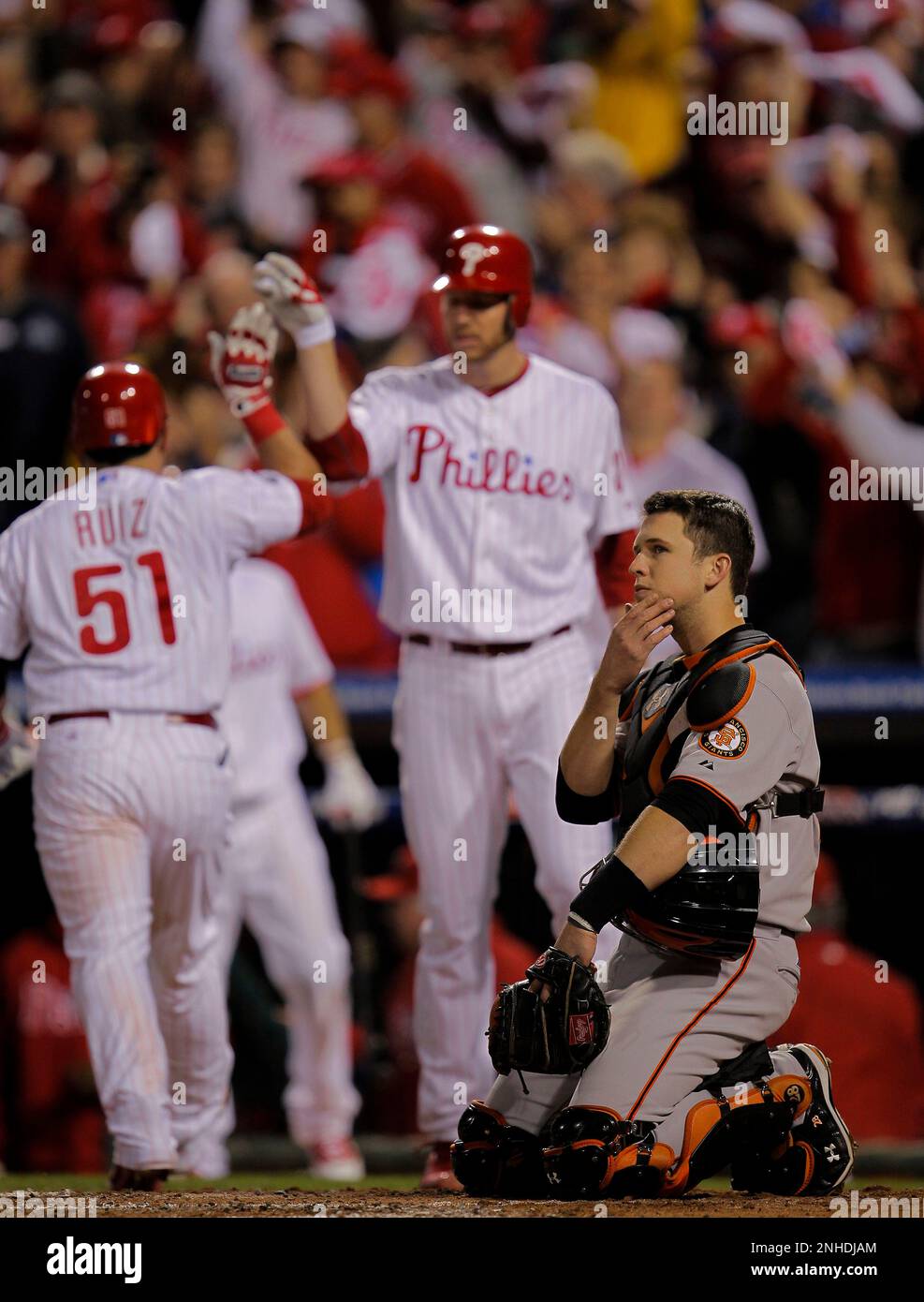 Giants catcher Buster Posey watches the Phillies' Carlos Ruiz hit a ...