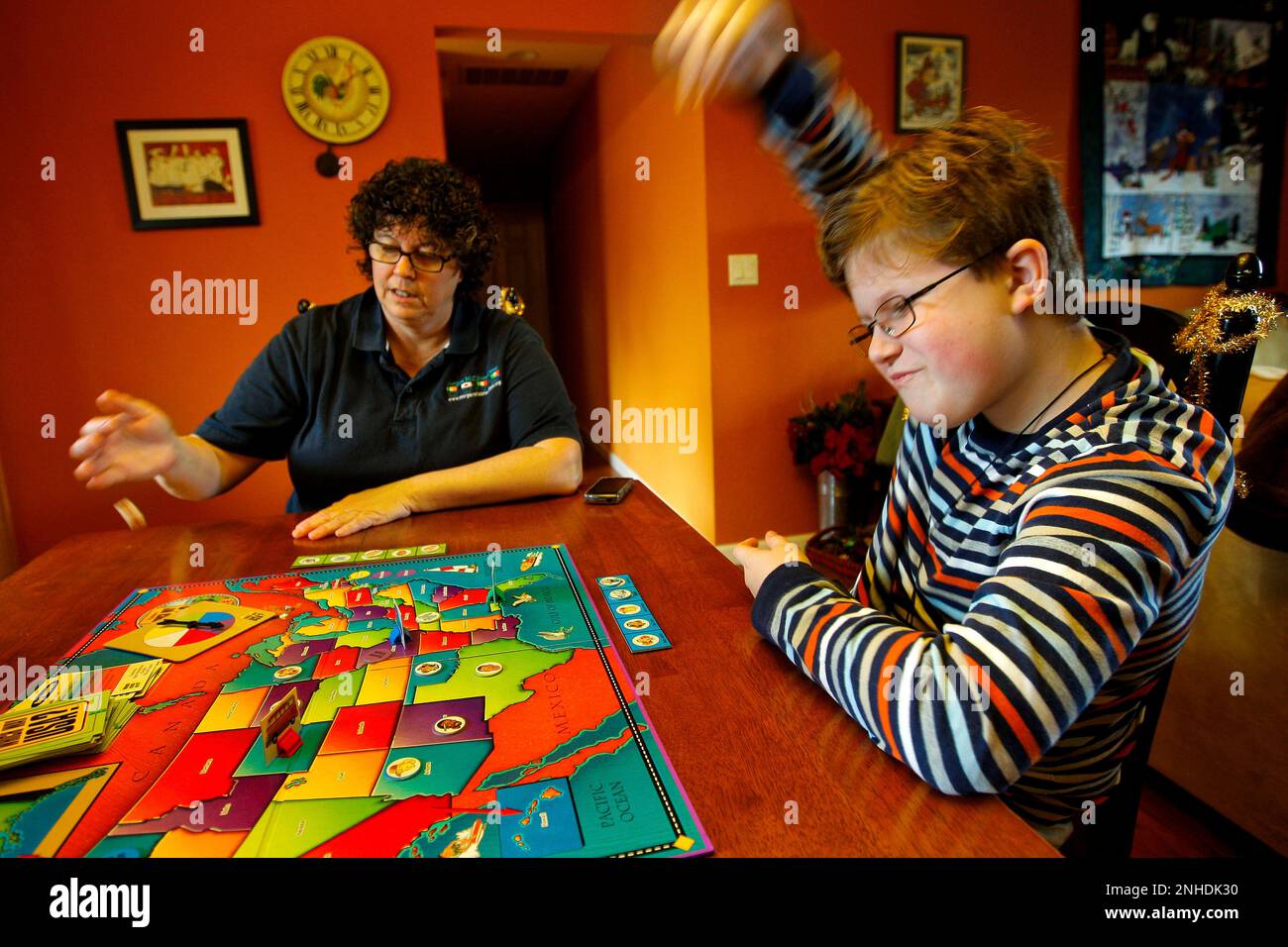Deborah Gustlin and her son Benjamin, playing a board game at their ...