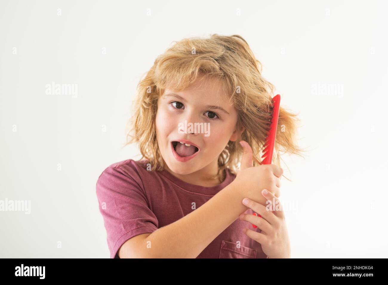Conditioner and shampoo for kids hair. Little child boy combing hair ...