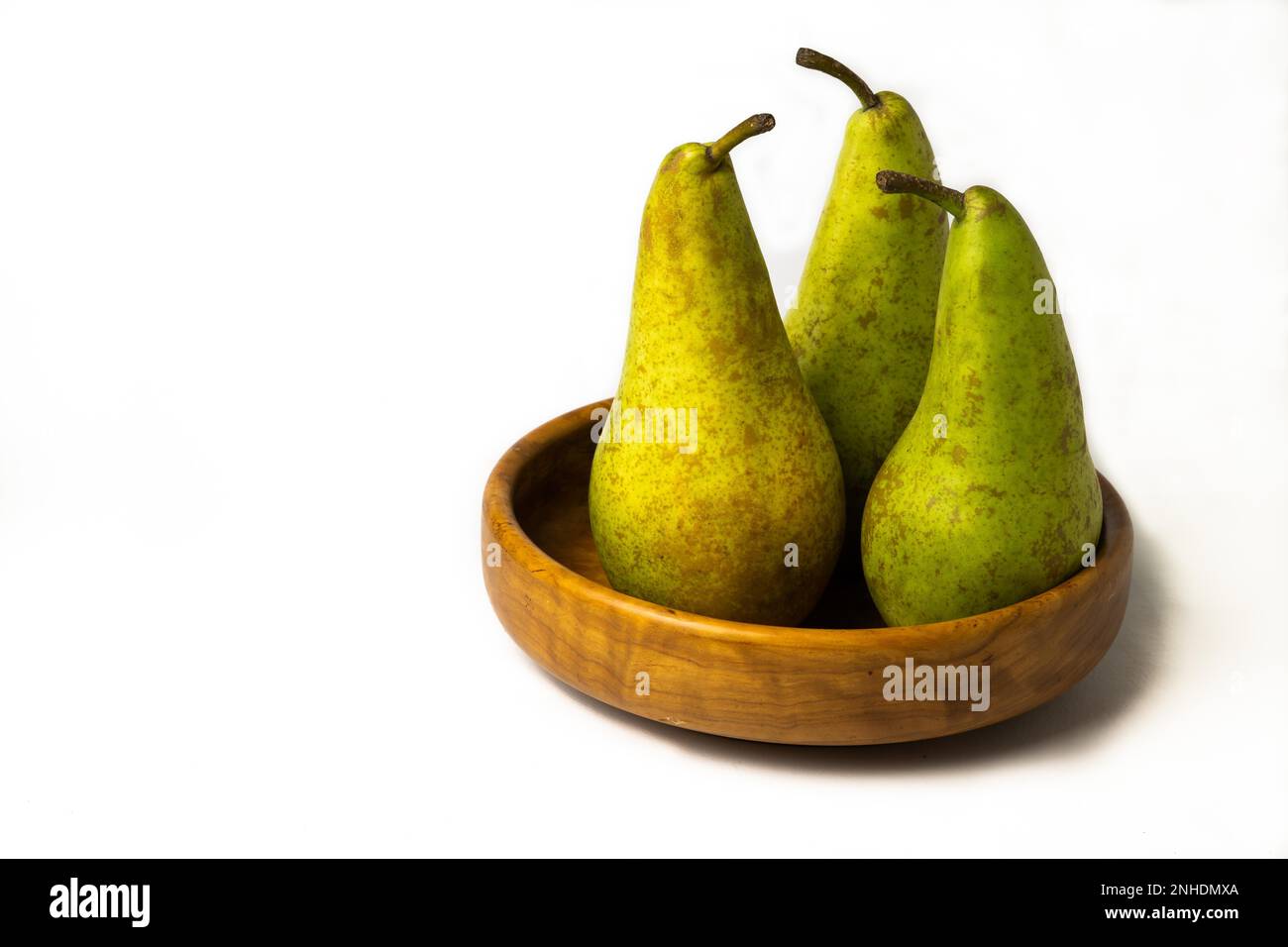 Green pears conference in foreground with copy-space and white ...