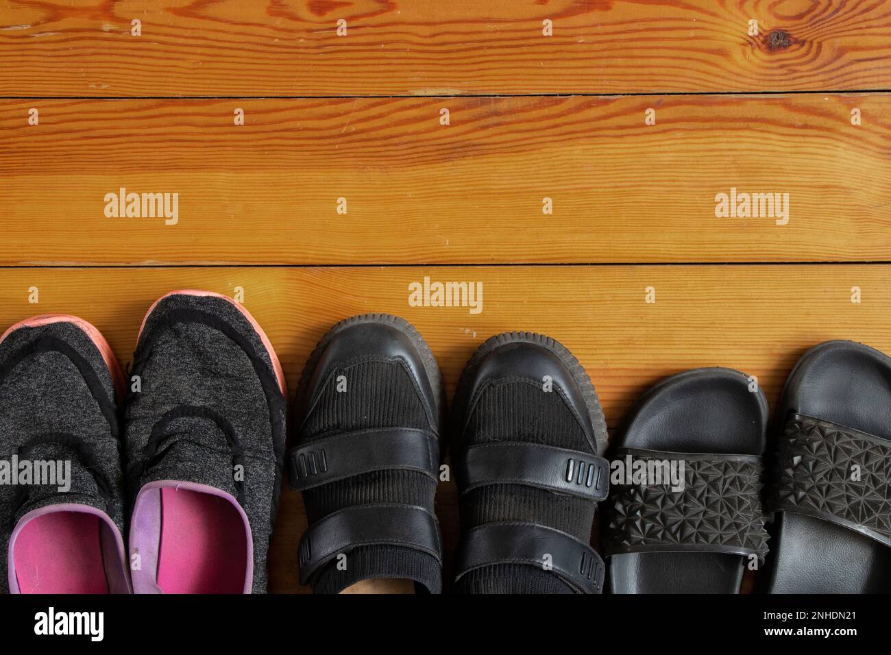sneakers flip flops sneakers are in a row on a wooden floor different ...