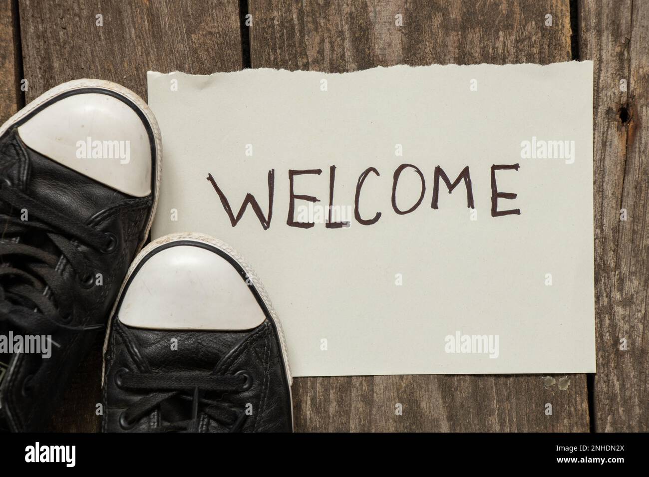 shoes are on the wooden floor next to a sheet of paper with the words ...