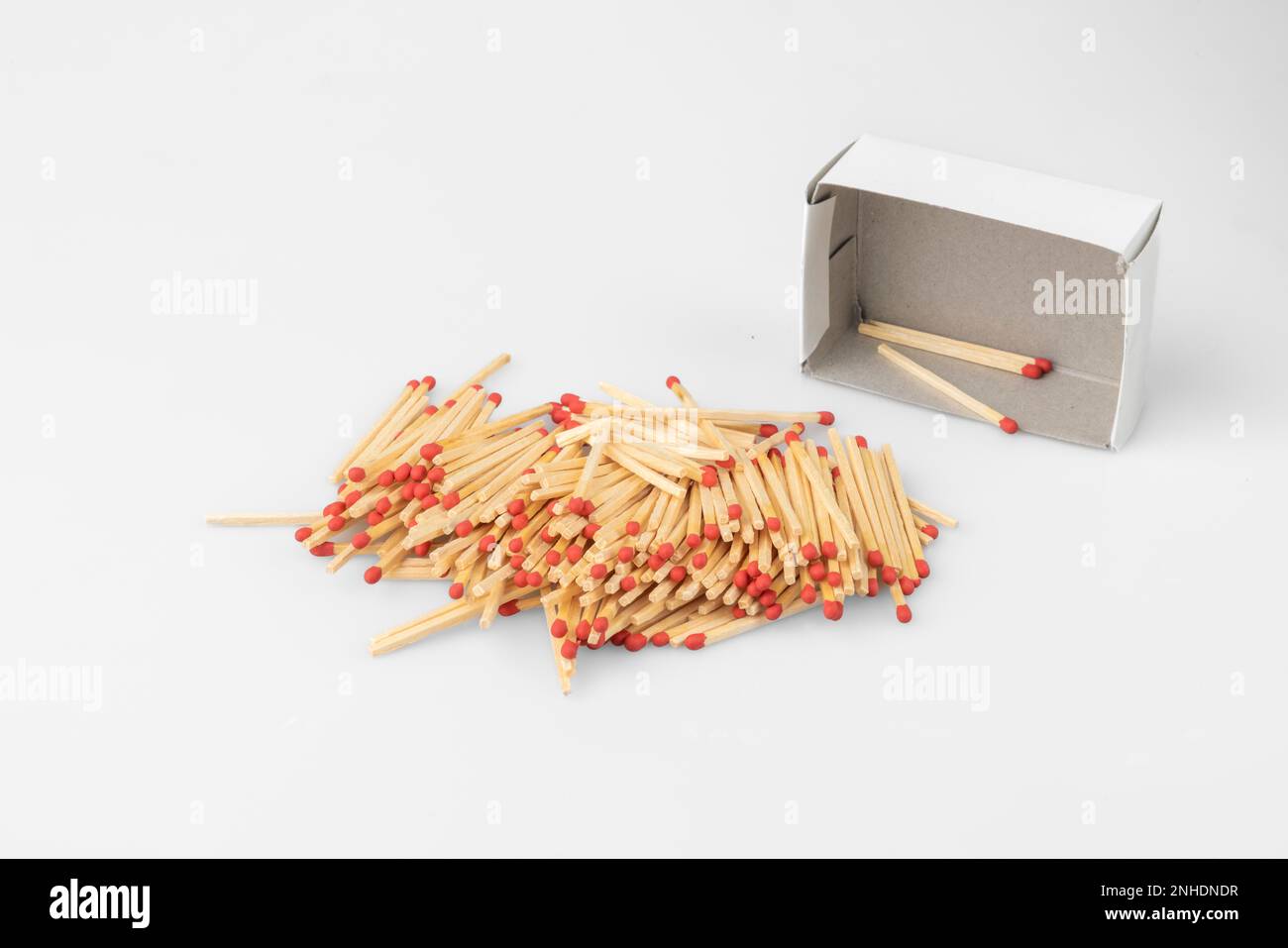 Stack of matches in front of almost empty box, white background Stock ...