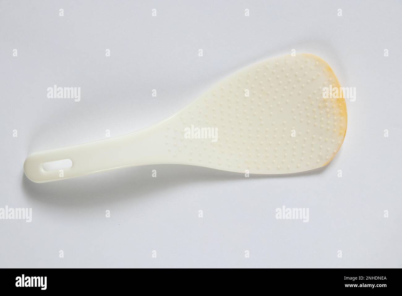 white plastic spoon lies on isolated light background close-up, spoon ...