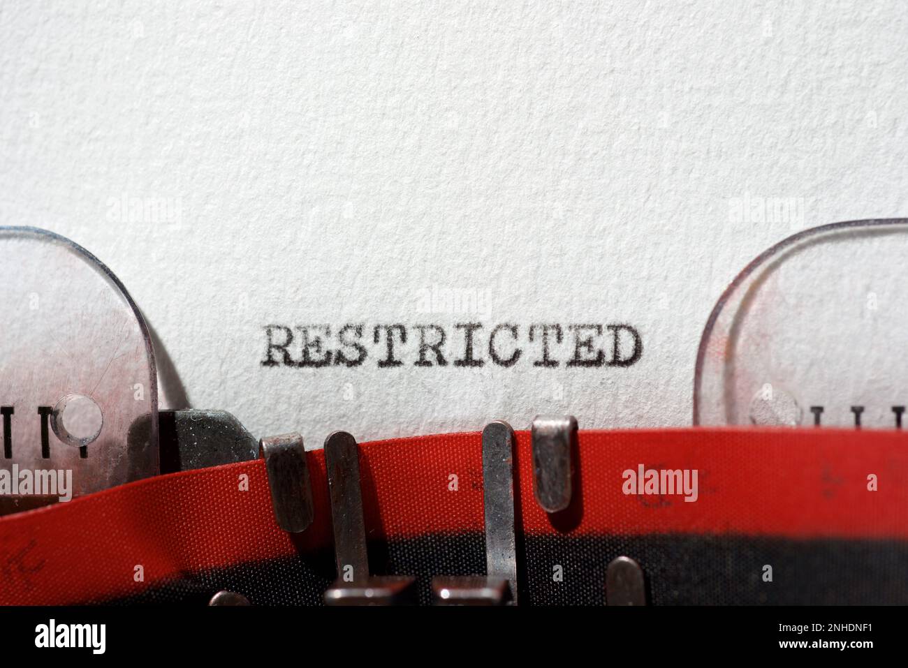 Restricted word written with a typewriter Stock Photo - Alamy