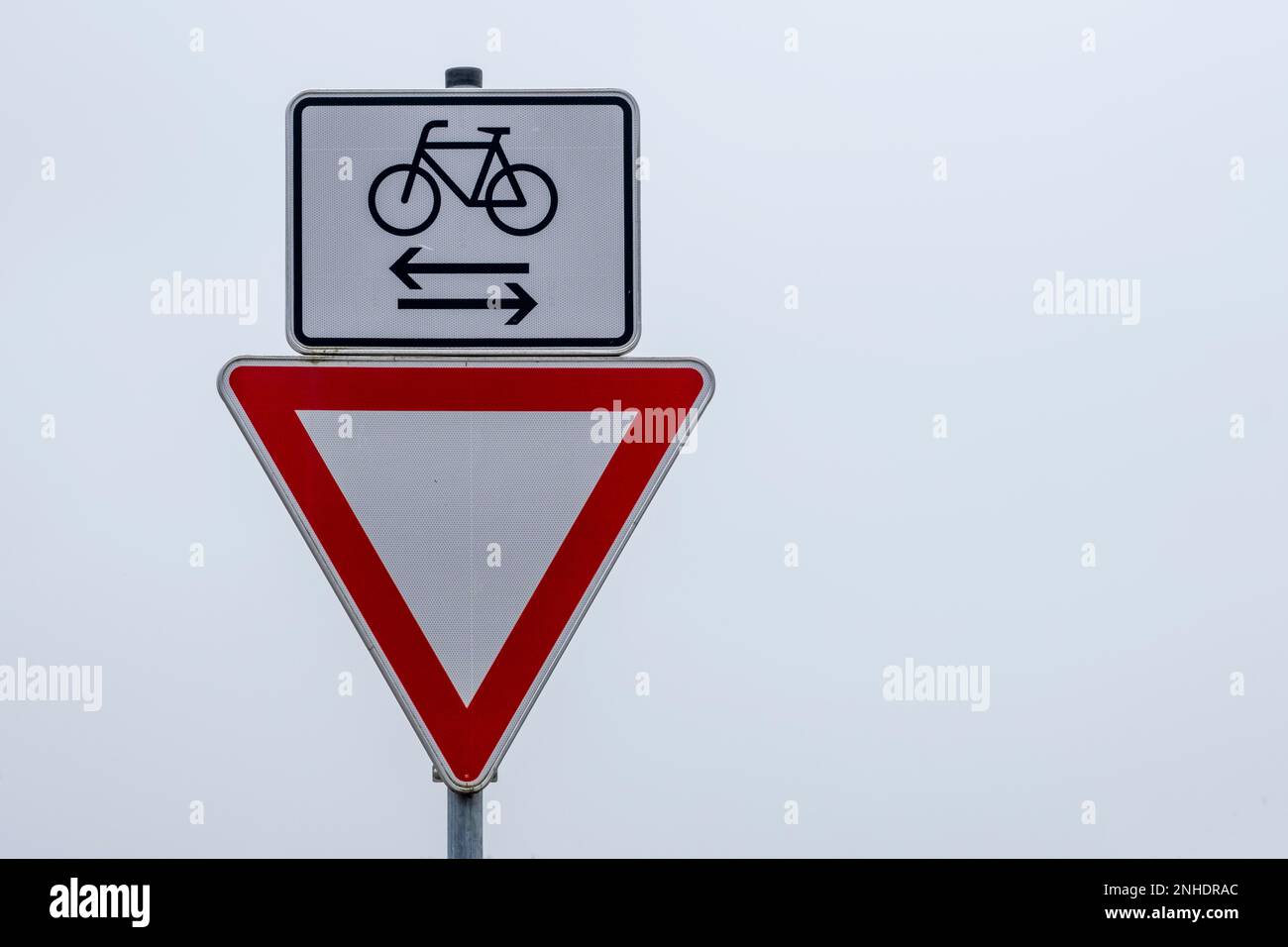 Road sign Give way and Attention cyclists from left and right Stock ...