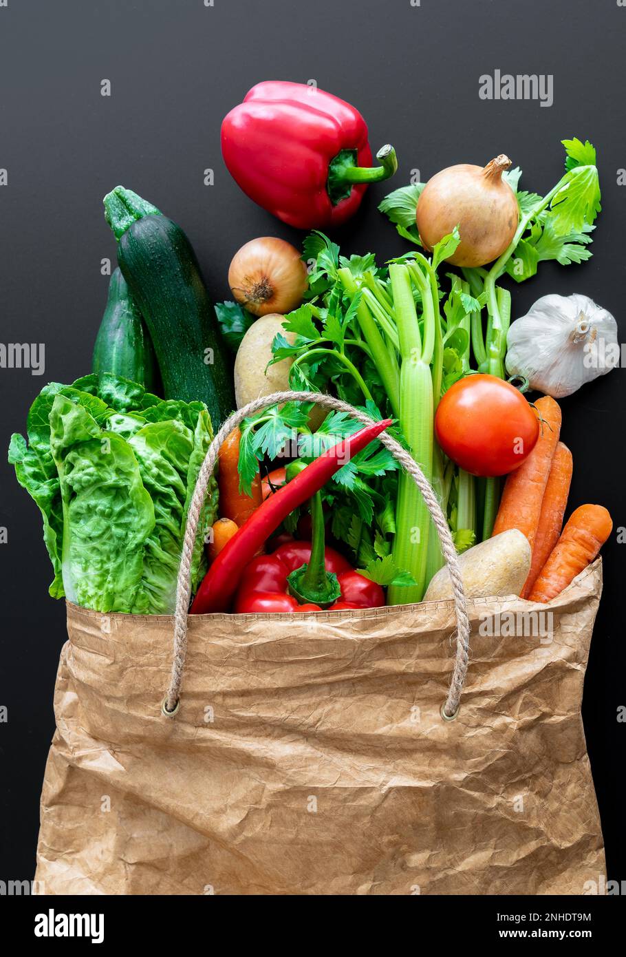 top view of fresh organic vegetables bought on weekly market in brown ...