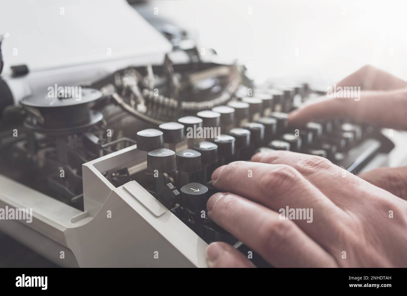 close-up shot of man typing on keyboard of old manual typewriter Stock ...