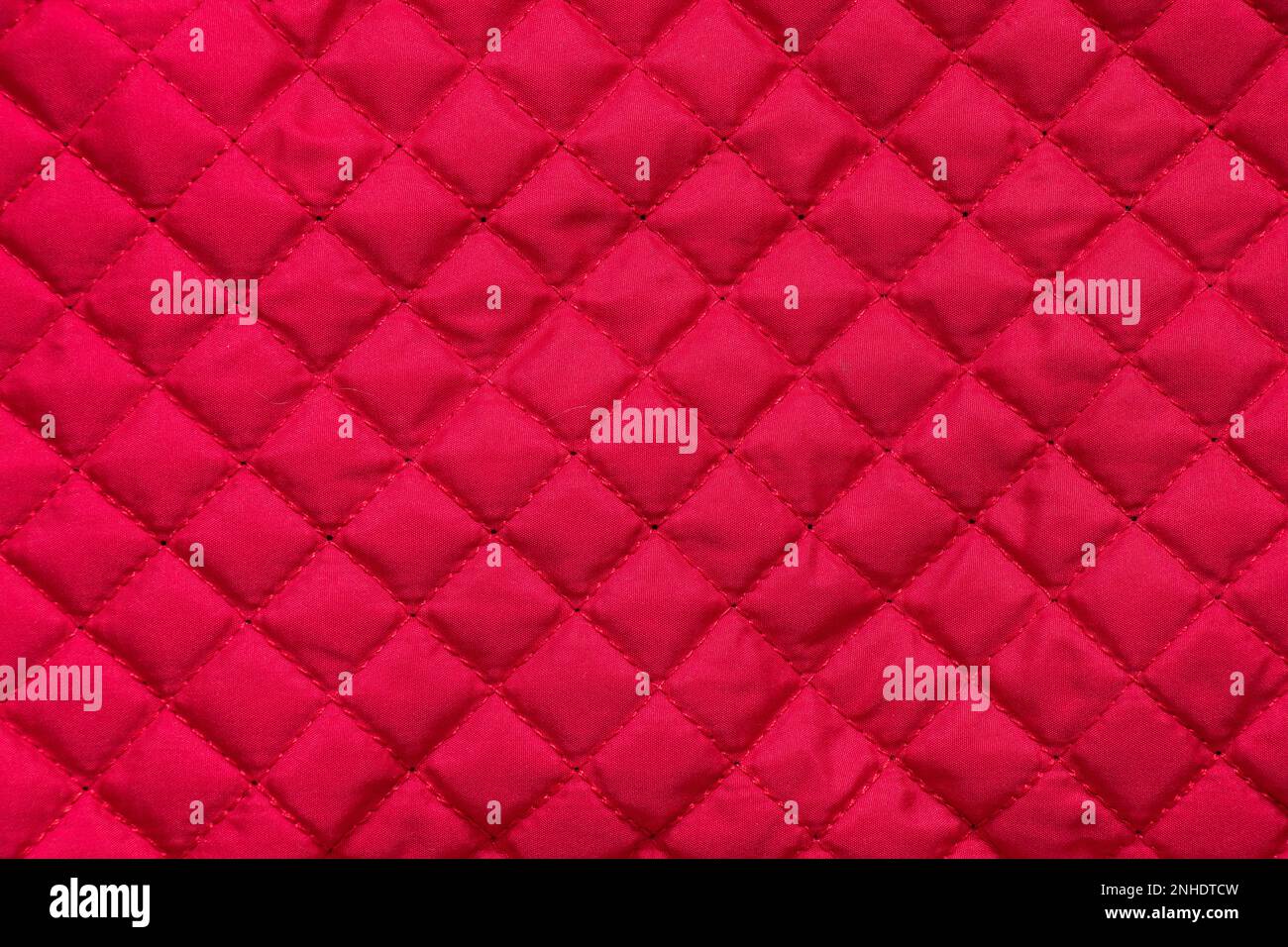 red stitched quilted bag cloth background closeup Stock Photo - Alamy