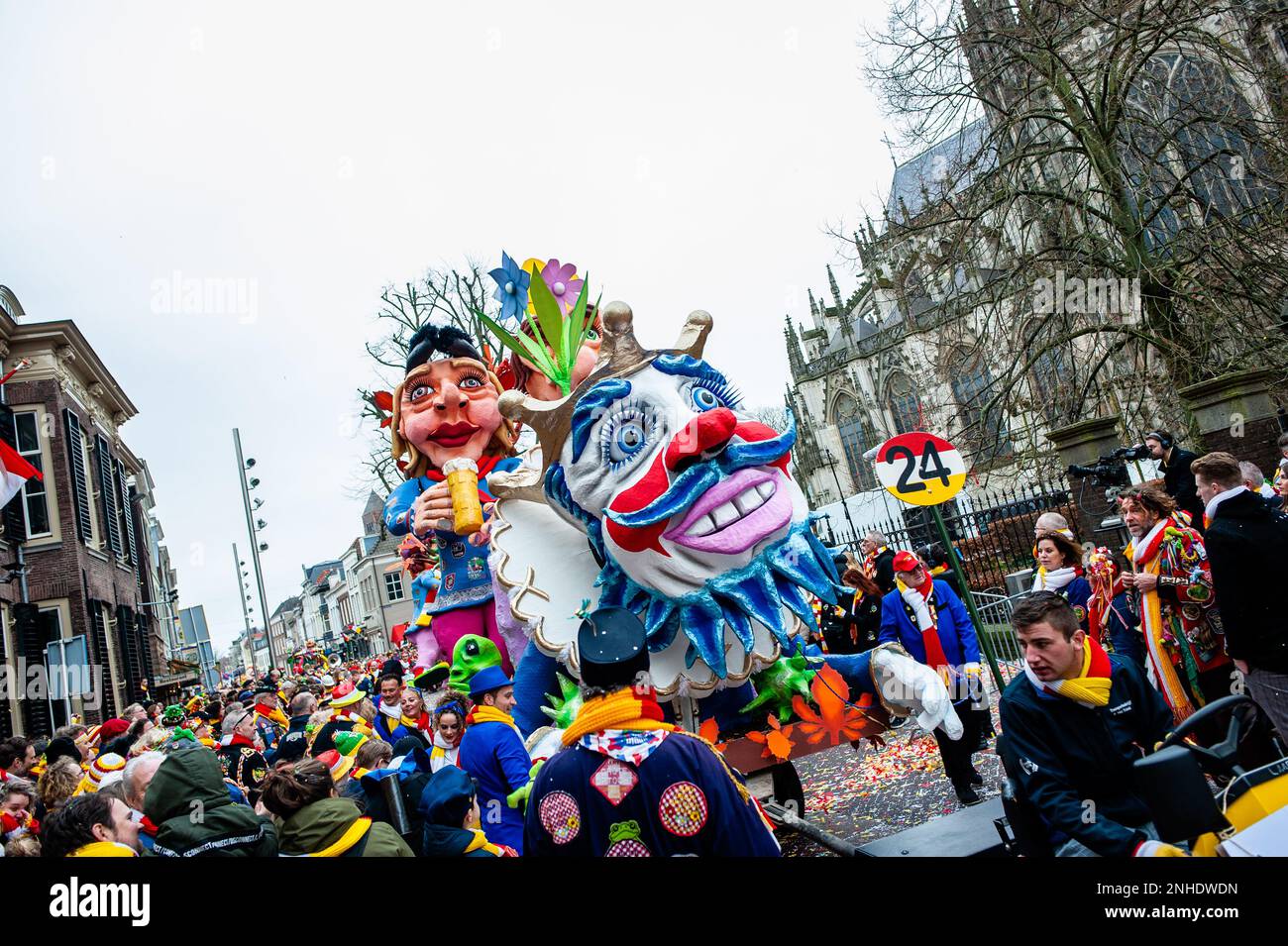 People are seen watching a very colorful and big float during the ...