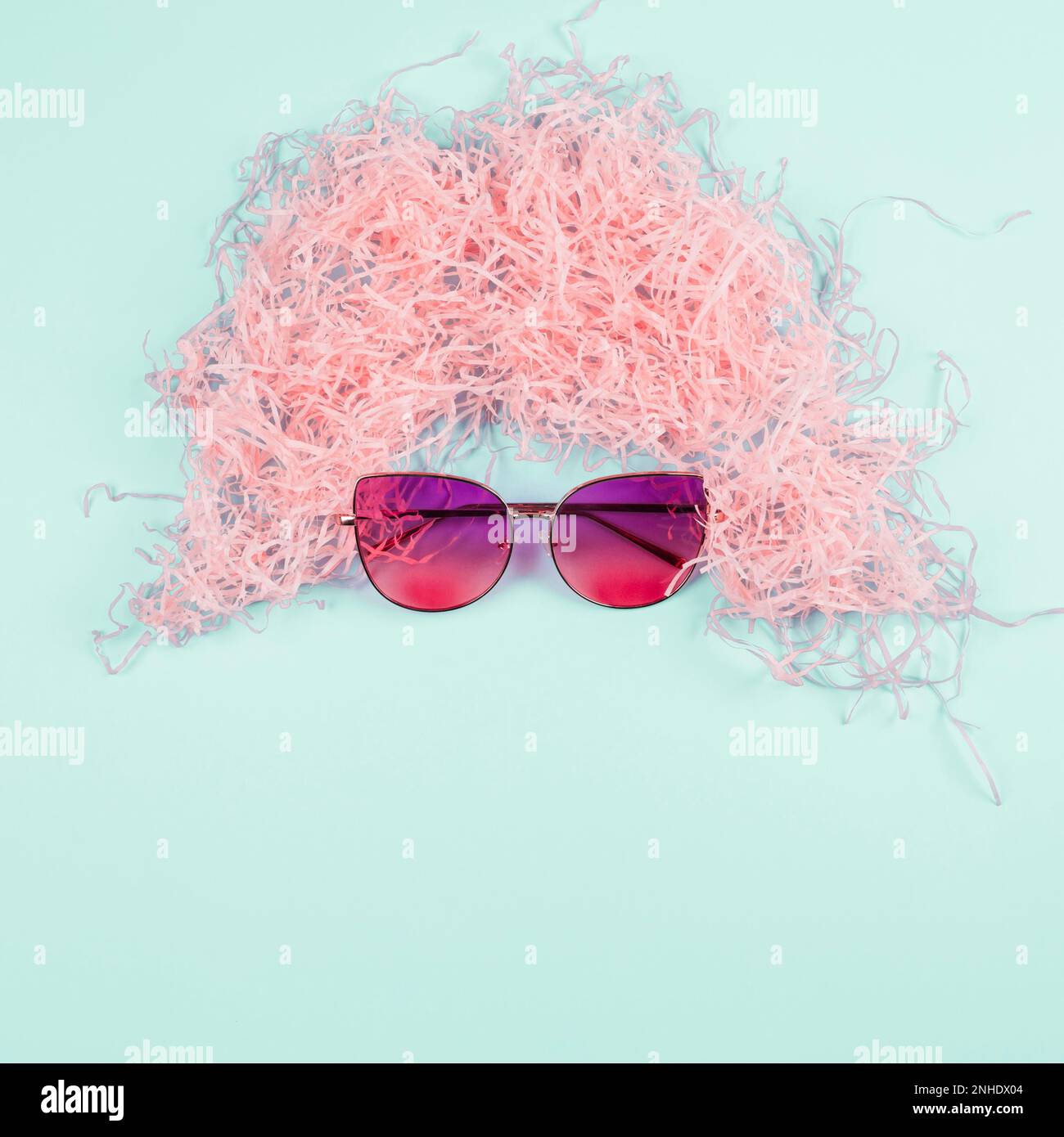 pink shredded paper wig sunglasses mint background Stock Photo - Alamy