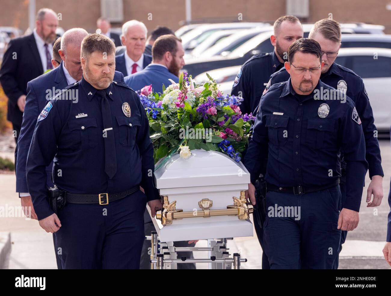 Law enforcement carry one of the children's caskets to a hearse ...