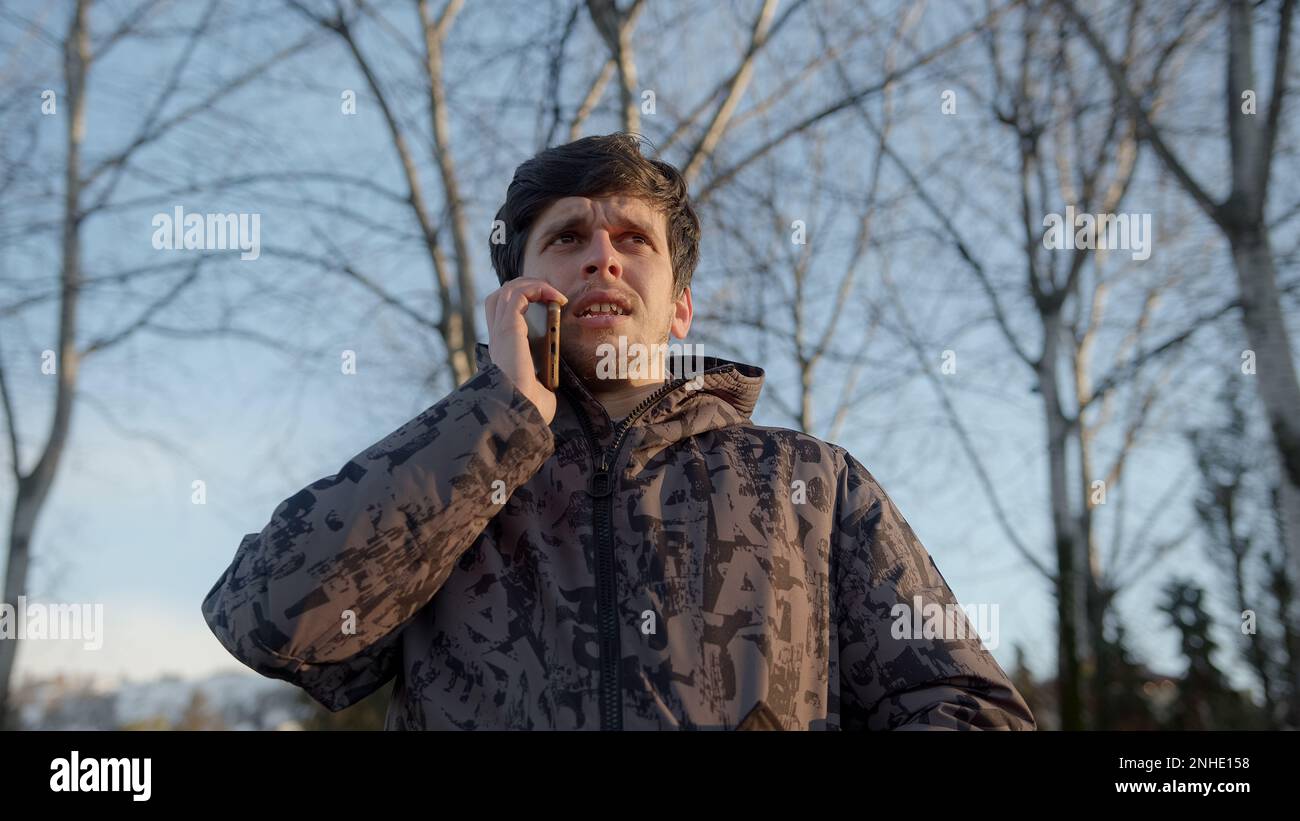 Stylish Black Sport Jacket Engaged in a Serious Phone Call Outdoors ...