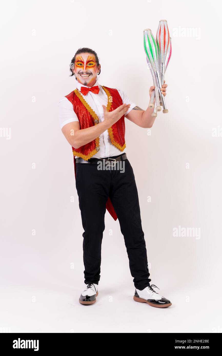 Smiling juggler juggling isolated on white background Stock Photo - Alamy