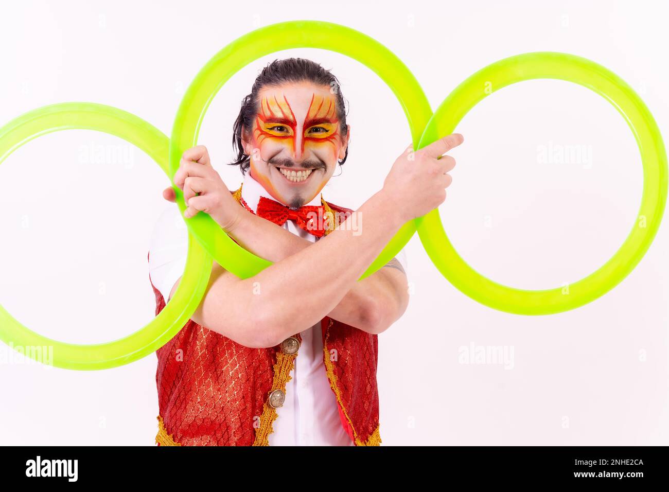 Portrait of a juggler smiling with juggling hoops isolated on white ...