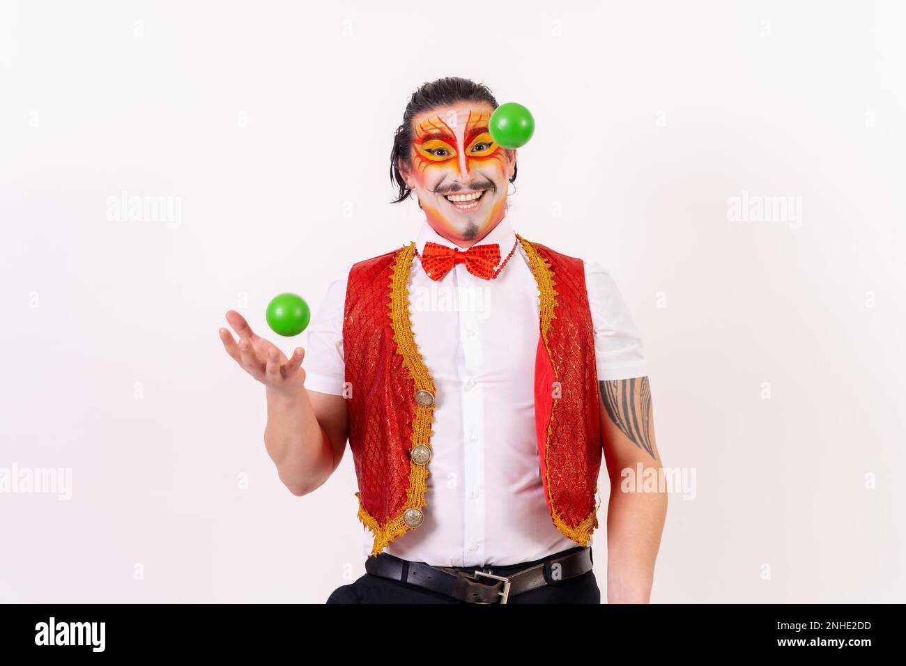Smiling juggler juggling green balls isolated on white background Stock ...